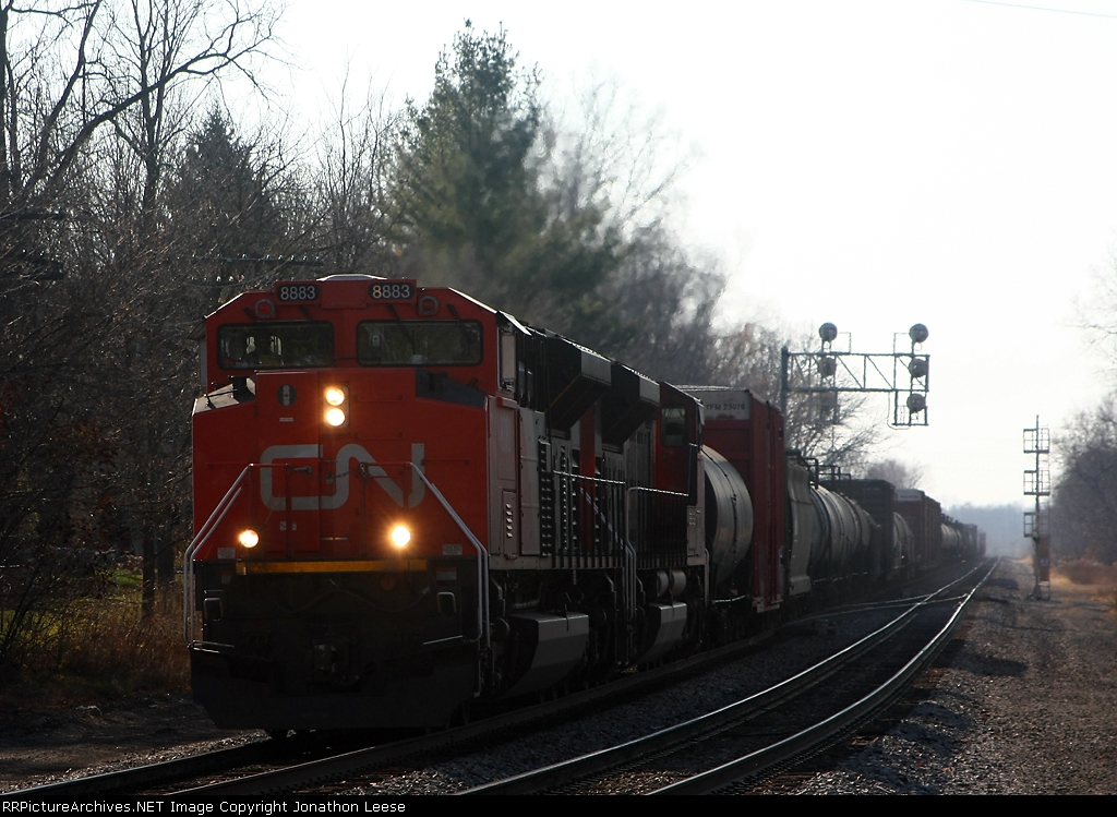 CN 8883 leads an eastbound under the signals at Oak St.